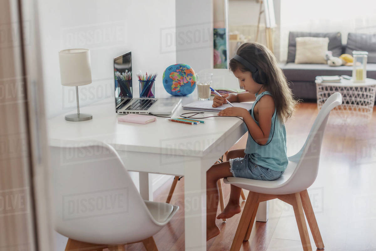 Little girl studying at home. - Stock Photo - Dissolve