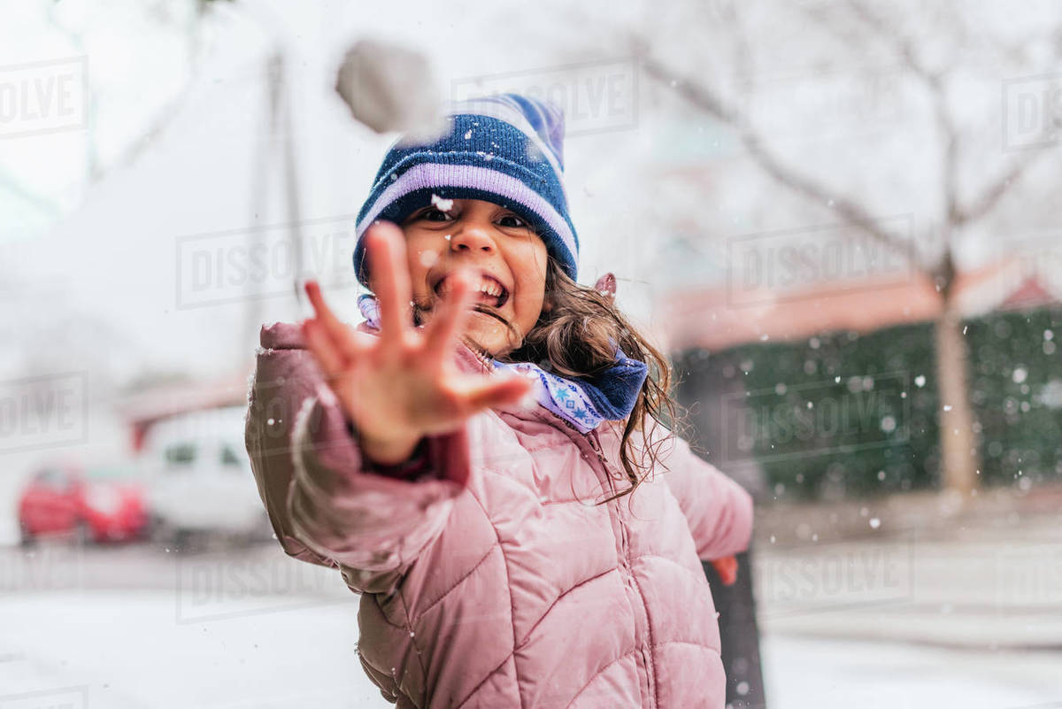 Girl throwing a snowball. - Royalty-free Stock Photo | Dissolve