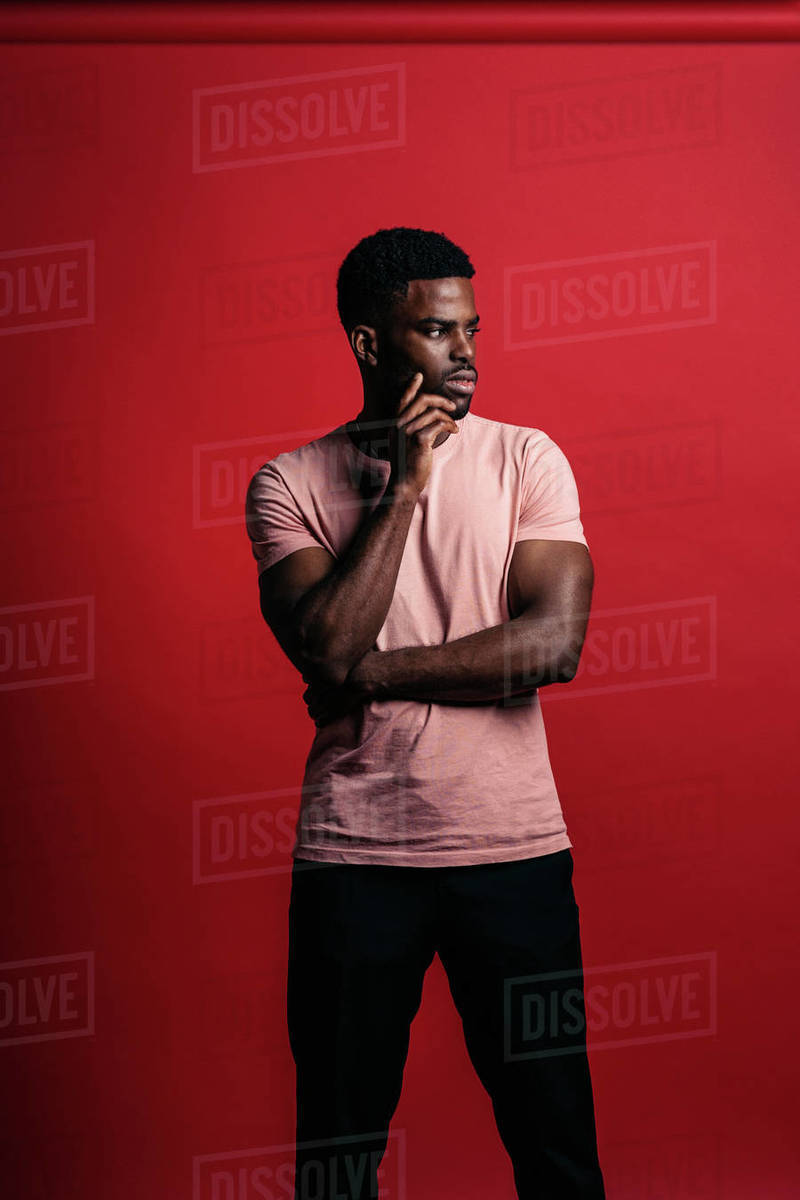 Portrait of young african man on bright red background - Stock Photo ...