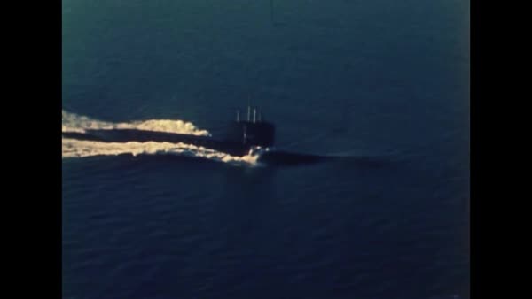 1964 - An aerial view shows a submarine breaching. An underwater view ...