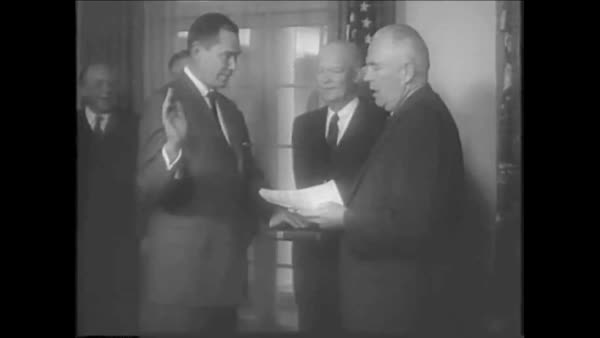 1957 - President Eisenhower looks on as Thomas Gates is sworn in as ...