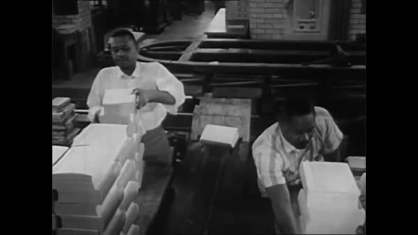 Bound pages are stacked off of a conveyor belt, and a Casing In Machine ...