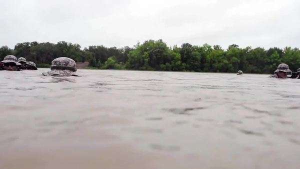 A National Guard SWAT team practices waterborne infiltration techniques ...