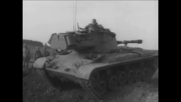 1950 - Tanks are maneuvered over craters and the 2nd armored division ...
