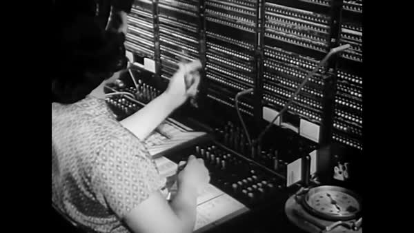 A telephone operator demonstrates how to quickly make a long-distance ...