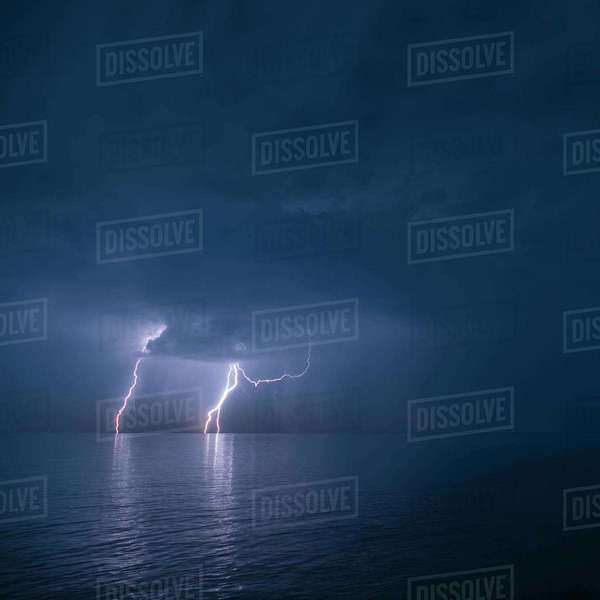 Lightning over water. Electric discharge. Nature background for design ...