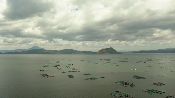 Lake Taal with a volcano and fish cages on a fish farm view from above ...