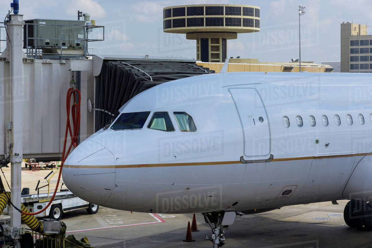 Jet engine against a middle size plane at the airport on loading ...