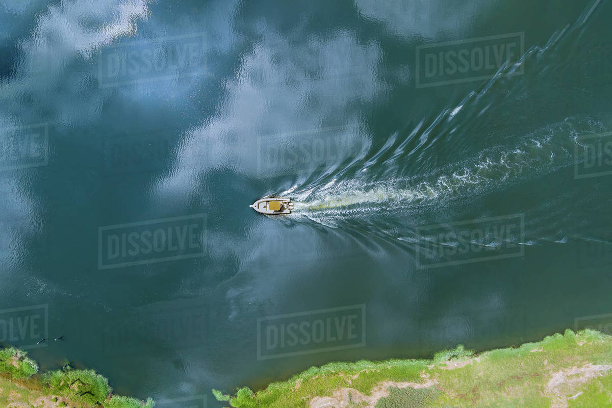 Aerial view of a boat floating on water - Stock Photo - Dissolve