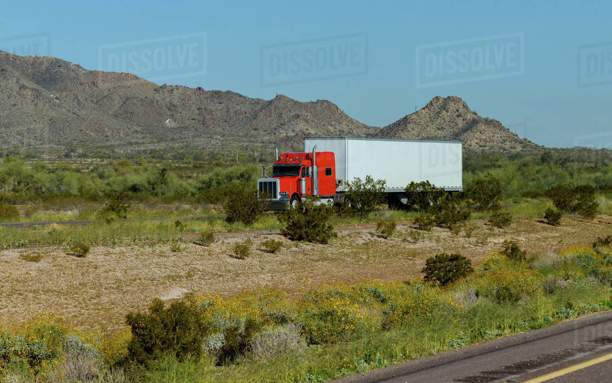Classic American big rig semi truck with transporting on flat bed semi ...