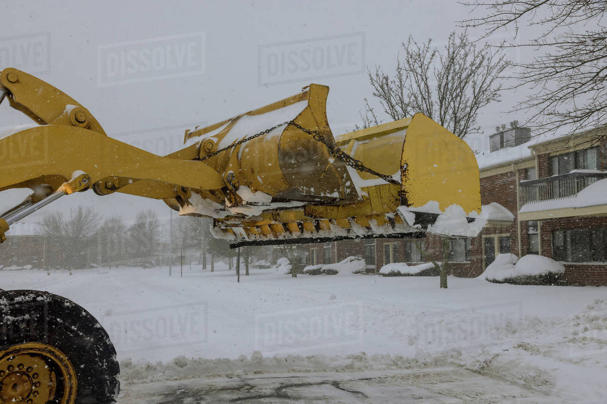 Snow clearing tractor clears the way after heavy snowfall for vehicle ...