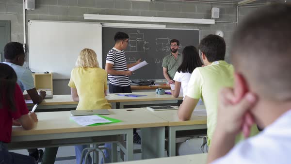 Latin American college student presenting a project reading a ...