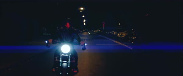 TRACKING Shot of a biker riding his custom built cafe racer motorcycle ...