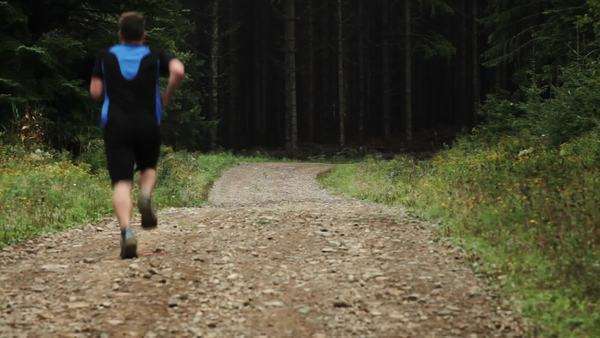 Man running alone on a gravel road in forest - Stock Video Footage ...