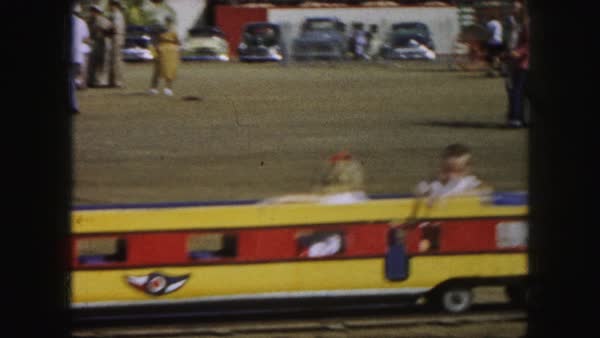 1958: two children riding in a small train ride at a fair. - 4K Royalty ...