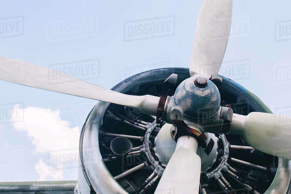 A close-up of an old aircraft engine showing rust and breakage. Visible ...