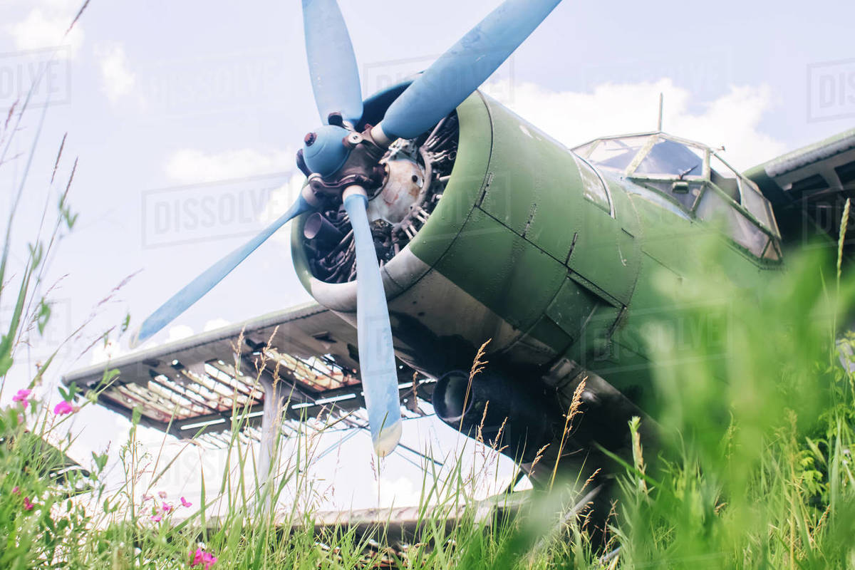 A close-up of an old aircraft engine showing rust and breakage. Visible ...