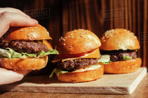 Mini burger on a stand close-up. Children fast food in a restaurant or ...