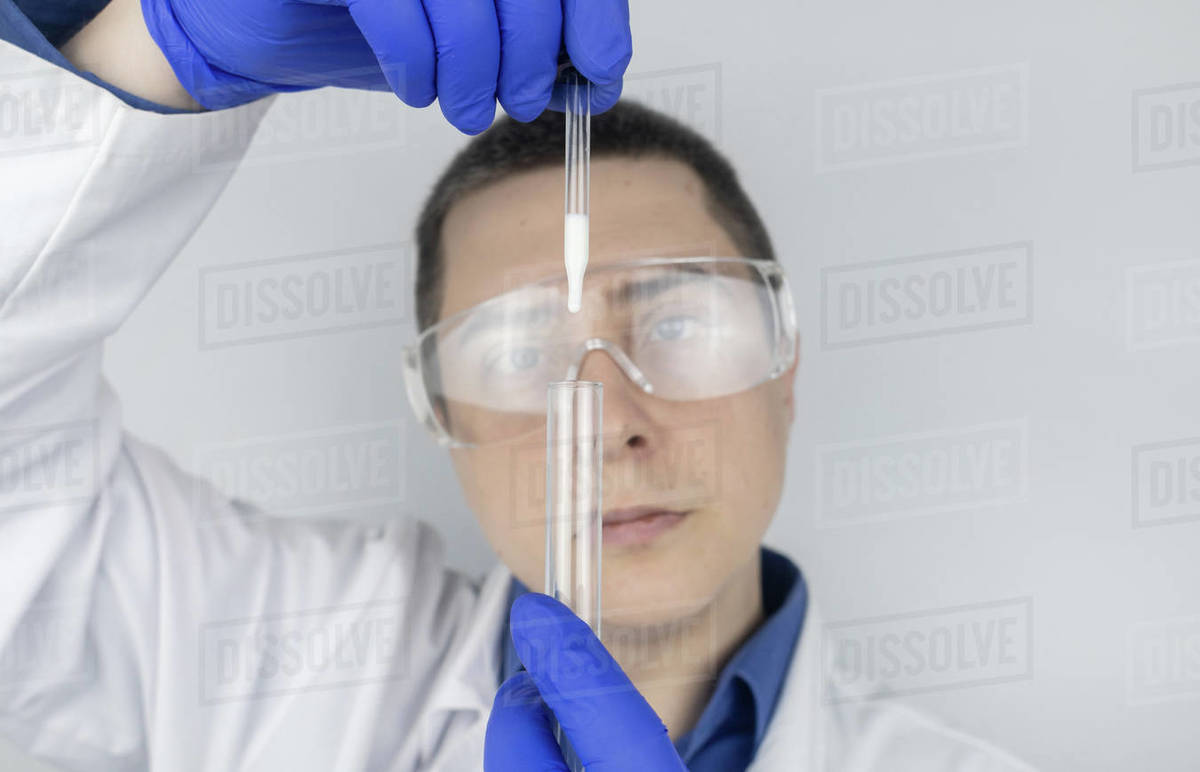 Medical laboratory assistant checks a test tube with sperm. Spermogram ...