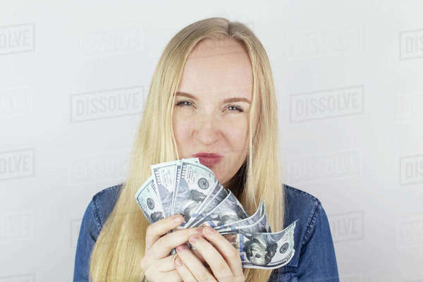 Close-up of a girl sniffing money. Madness and greed from currency. The ...