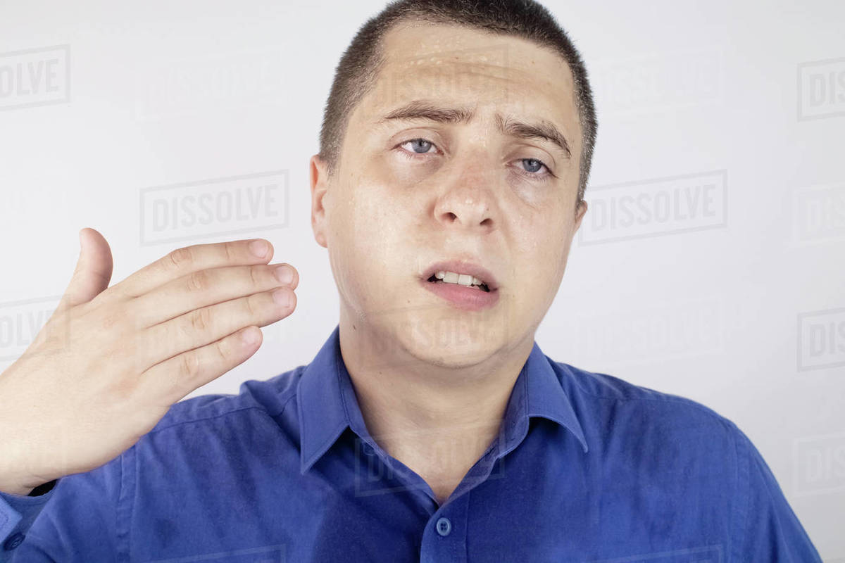 An office worker in a blue shirt looks at the camera. He covered in ...