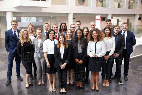 Portrait of staff standing in lobby of modern office - Stock Photo ...