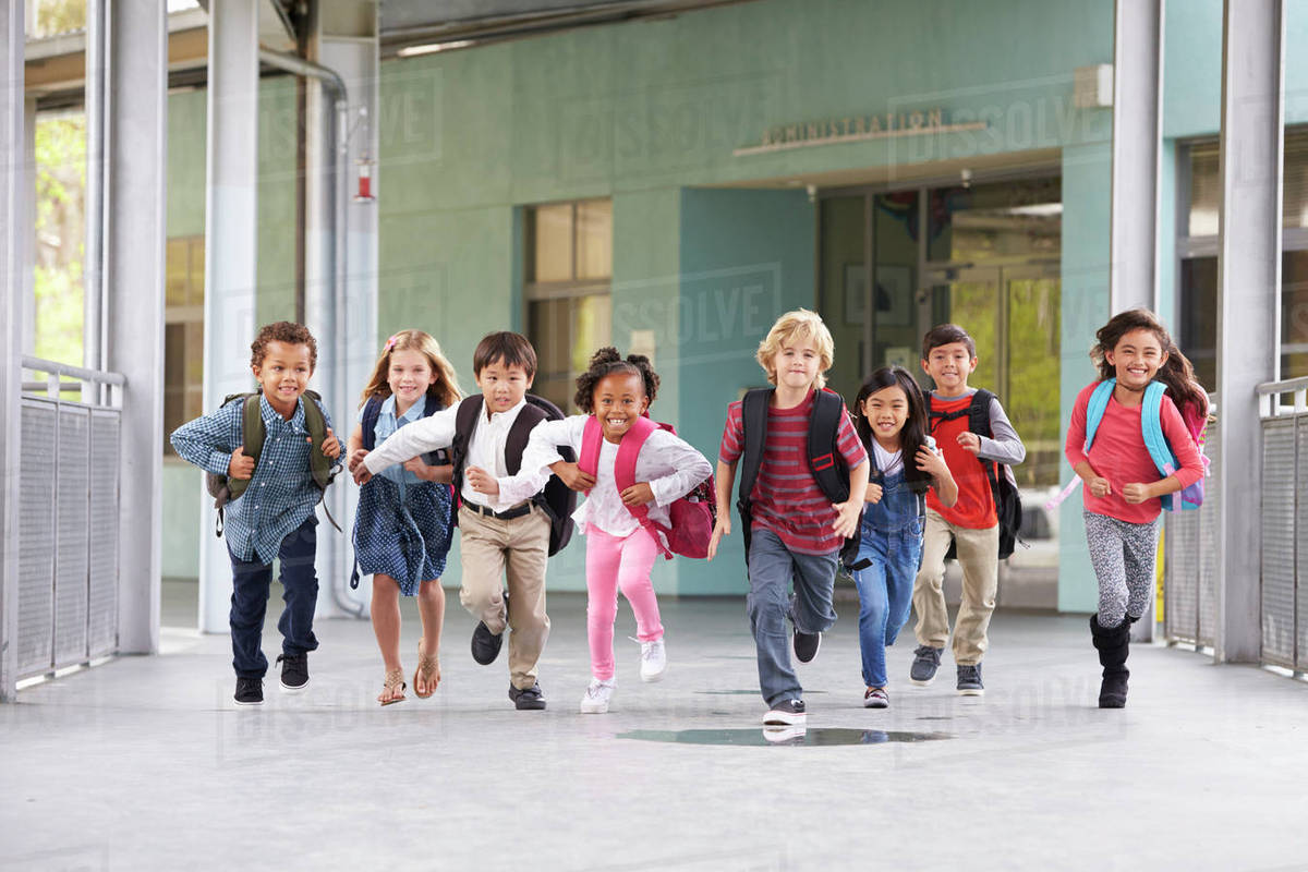 Group of elementary school kids running in a school corridor - Royalty ...