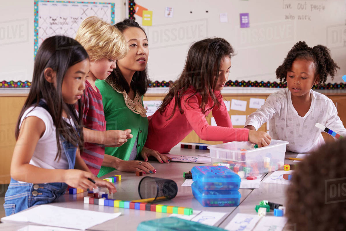 Elementary school teacher uses block play in class with kids - Stock ...