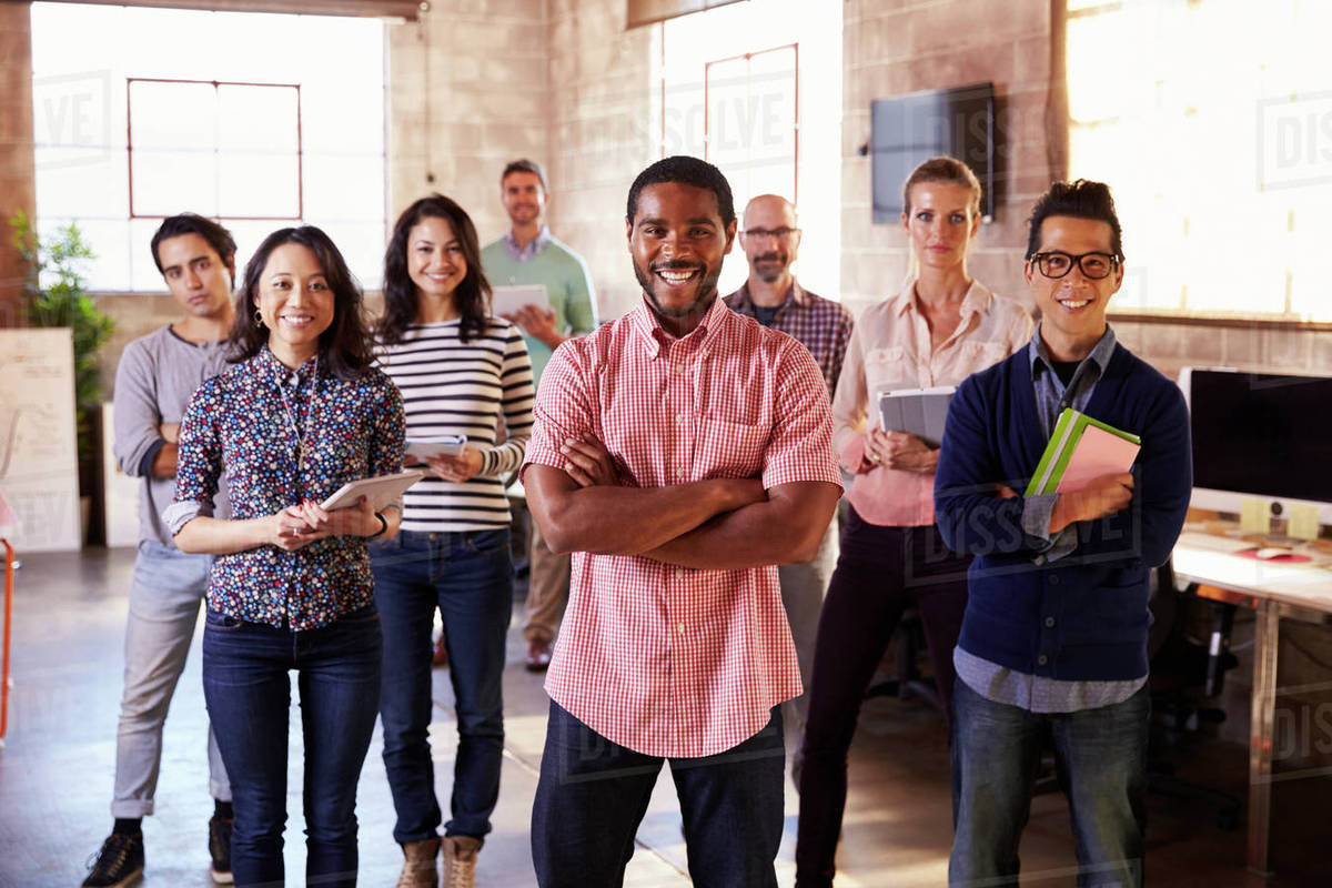 Portrait of staff standing in modern design office - Stock Photo - Dissolve
