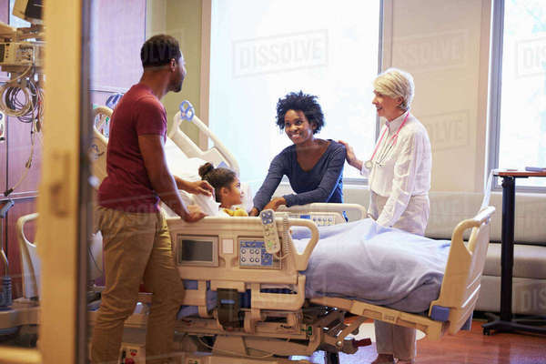 Pediatrician visiting parents and child in hospital bed - Stock Photo ...