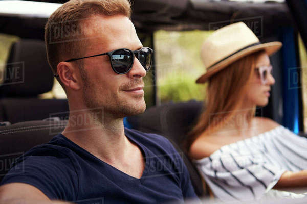 Young Couple Driving Open Top Car On Country Road - Royalty-free Stock ...