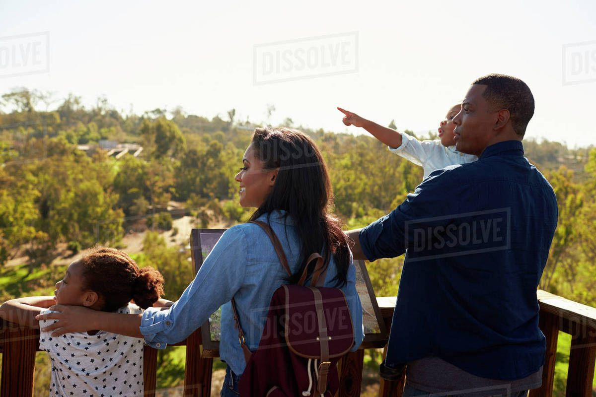 Family standing on outdoor observation deck looking at view - Stock ...