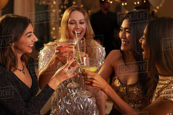 Female friends make toast as they celebrate at party - Royalty-free ...