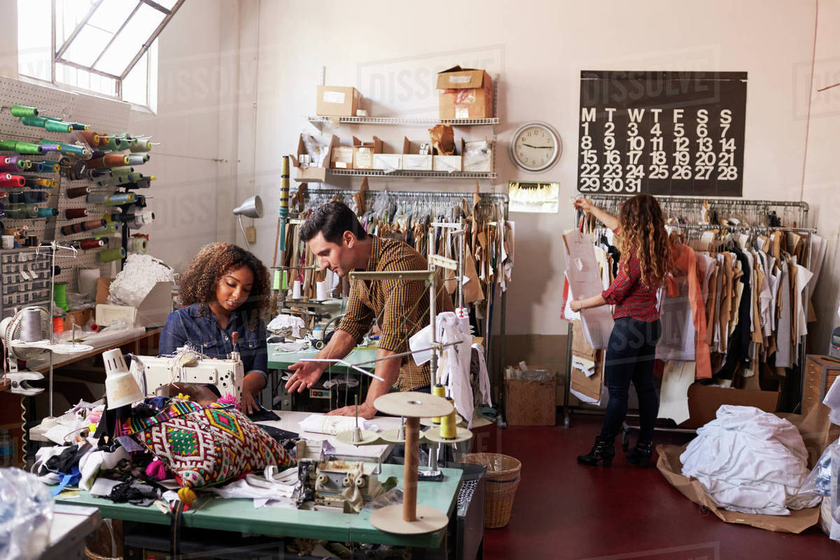 Team at work at a clothes manufacturing workshop - Stock Photo - Dissolve