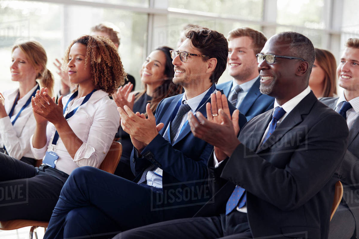 Smiling audience applauding at a business seminar - Royalty-free Stock ...