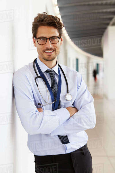 Portrait of young male doctor with stethoscope, smiling - Royalty-free ...