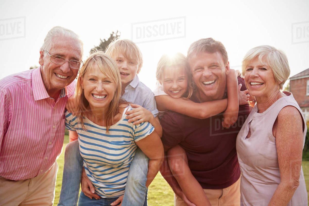 Multi generation family in garden smile to camera, close up - Royalty ...