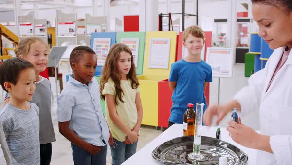 School kids watching an experiment at a science centre - Stock Video ...