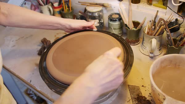 Close Up Of Male Potter Shaping Clay For House Sign On Pottery ...