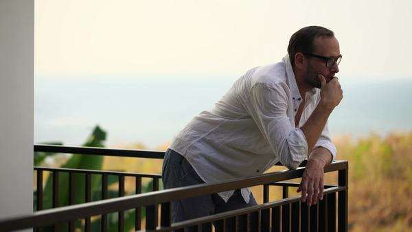 Sad, depressed young man standing on terrace - Stock Video Footage ...