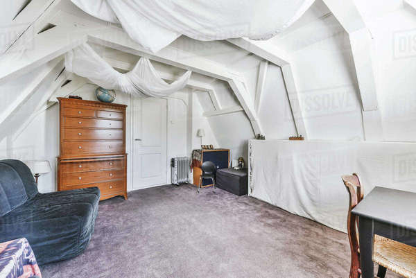 Interior of upper floor room with beams and canopy on white ceiling ...