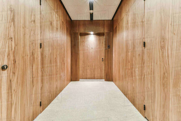 Perspective view of hallway with walls in luxury wooden panels in soft ...