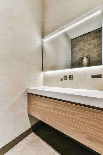 Minimalist wooden cabinet with double washbasins and wall mount faucets ...