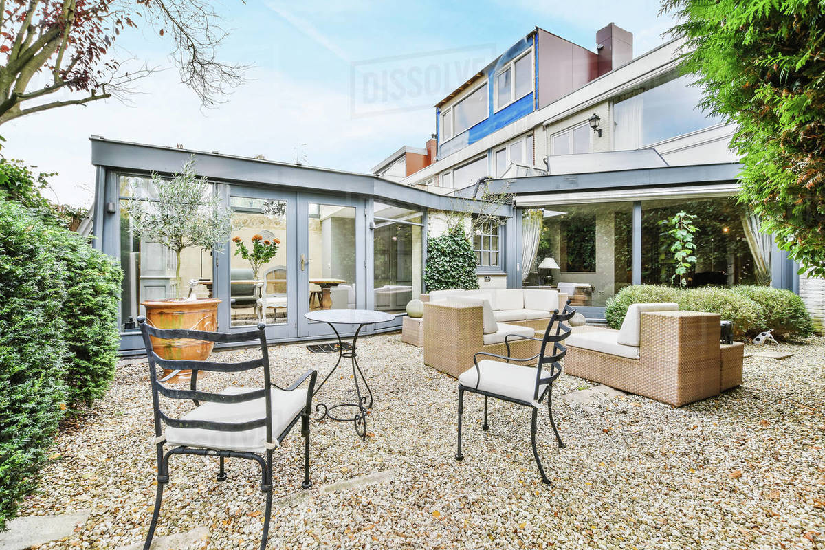 Beautiful backyard terrace full of furniture and decorative plants ...