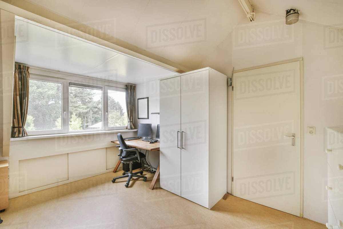 Comfortable work area with a window next to the table - Stock Photo ...