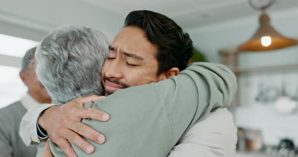 Family, hug and senior parents with adult son in a living room for ...