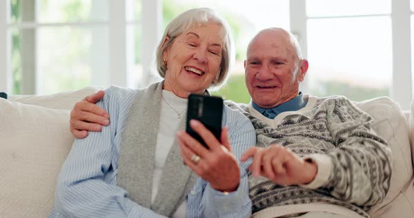 Old couple, video call and talking on sofa wave for online ...