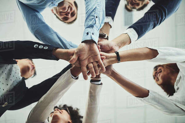 Team of business people hands stacked showing teamwork, collaboration ...