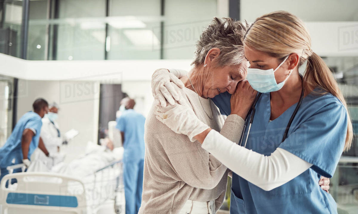 Doctor, hug and sad senior woman in hospital for support, comfort and ...