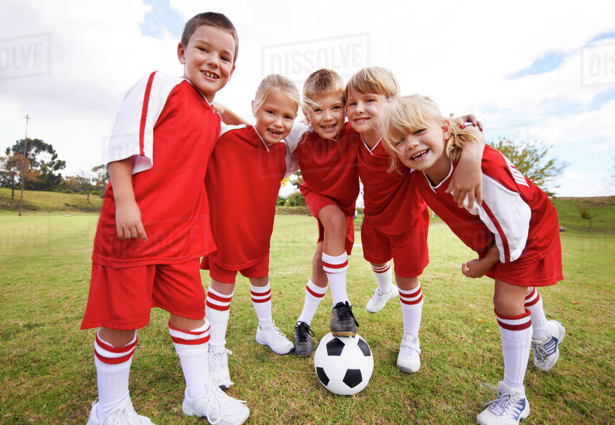 Children, group portrait and soccer team on field, happy and ...